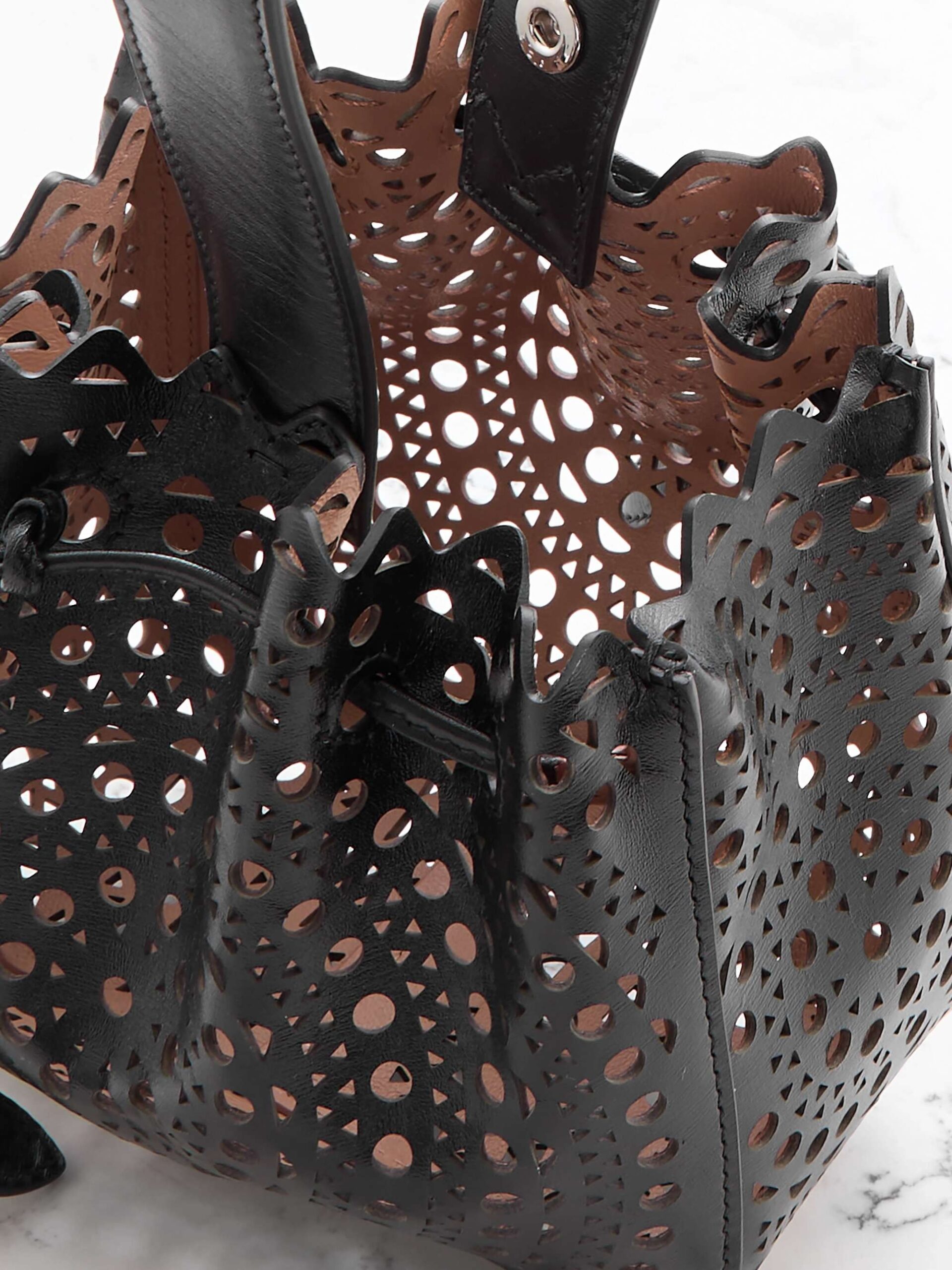 ALAÏA Rose Marie Small Laser-cut Leather Bucket Bag - We Select Dresses